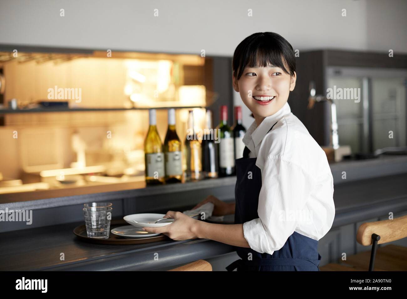 Young Japanese woman working at a restaurant Stock Photo - Alamy