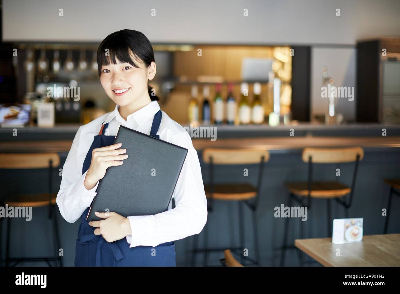 Young Japanese woman working at a restaurant Stock Photo - Alamy