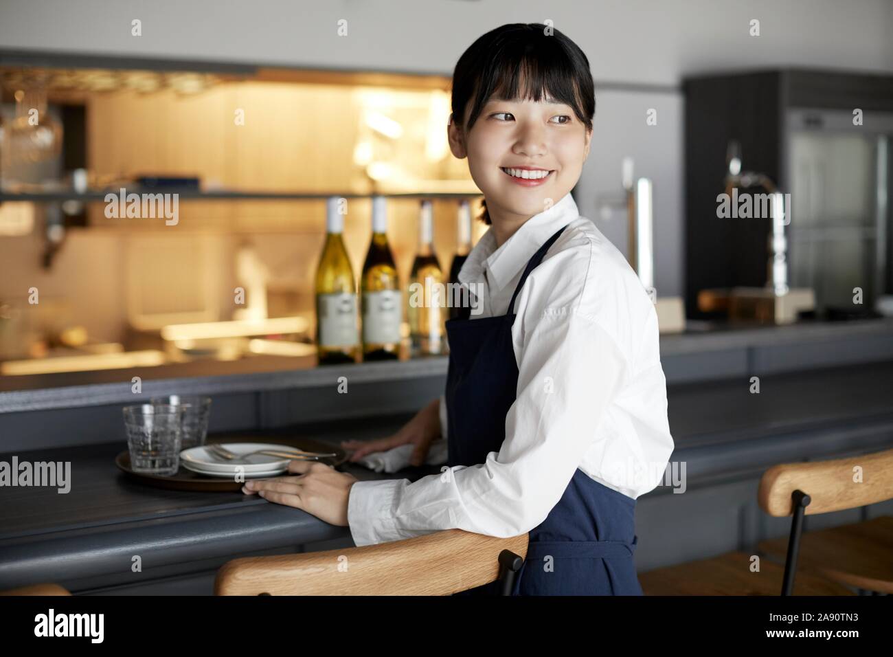 Young Japanese woman working at a restaurant Stock Photo - Alamy