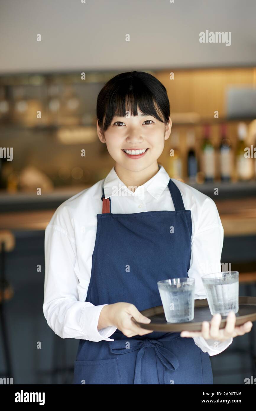 Young Japanese woman working at a restaurant Stock Photo - Alamy