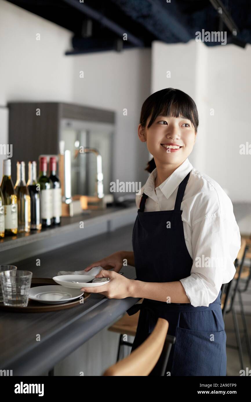 Young Japanese woman working at a restaurant Stock Photo - Alamy