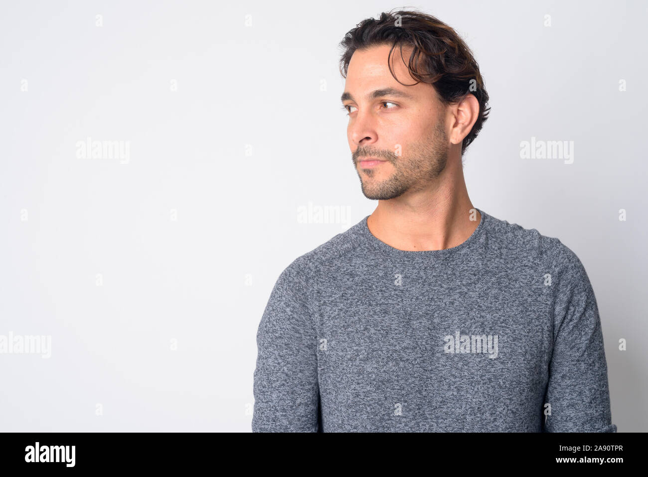 Face of handsome Hispanic man thinking and looking away Stock Photo - Alamy