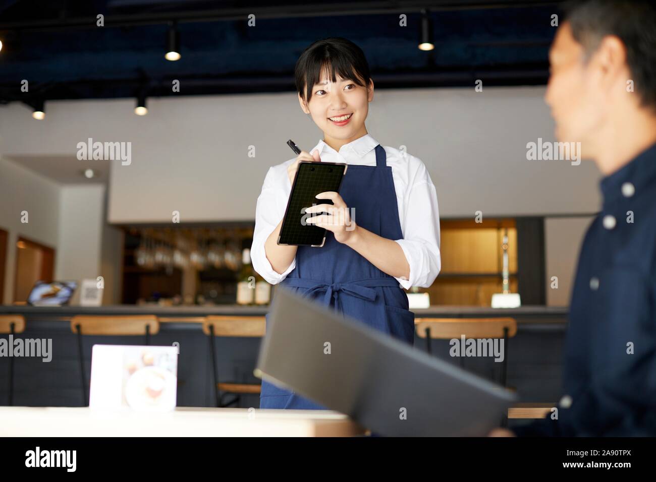 Young Japanese woman working at a restaurant Stock Photo - Alamy