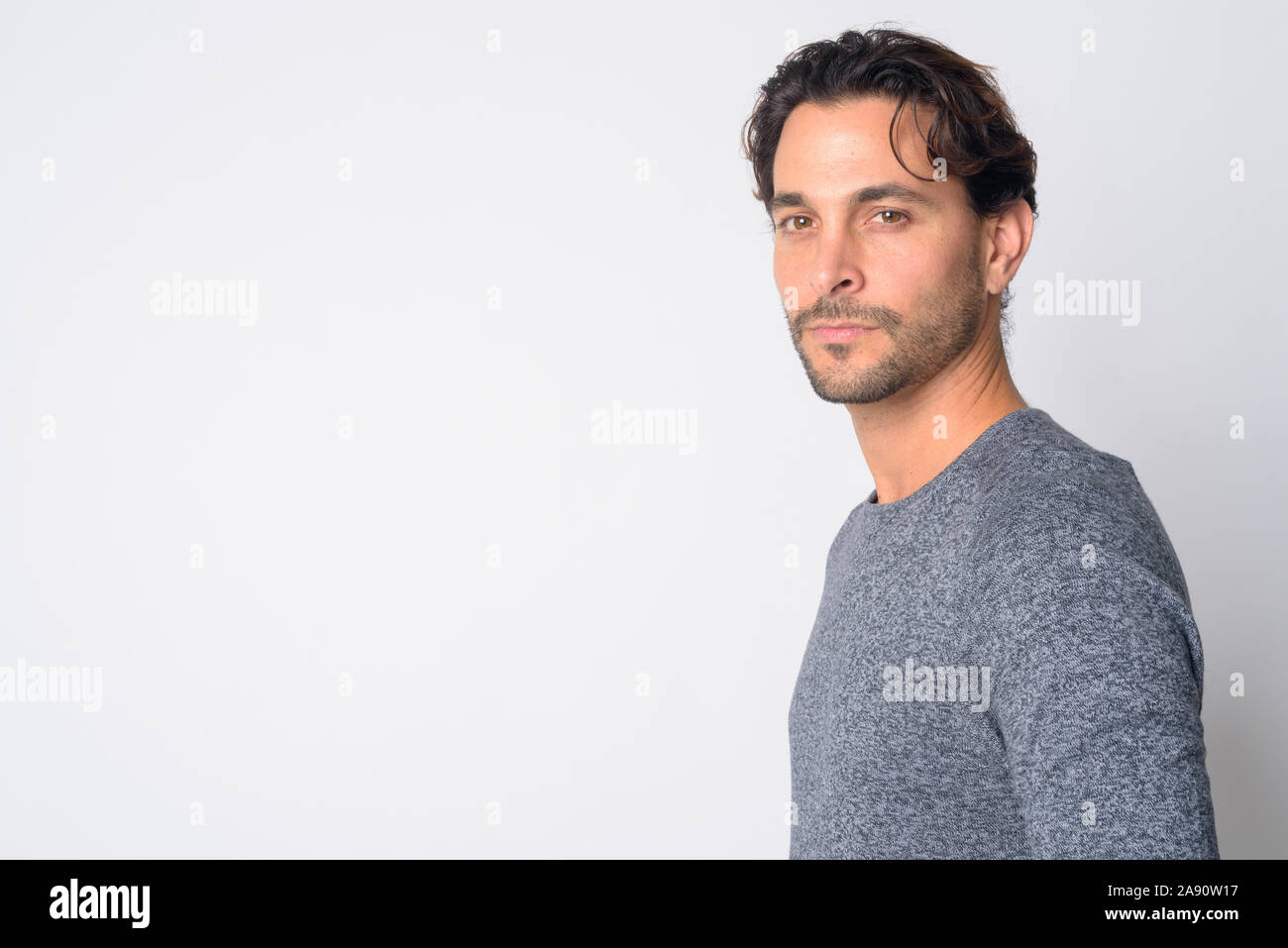 Closeup profile view of handsome Hispanic man looking at camera Stock ...