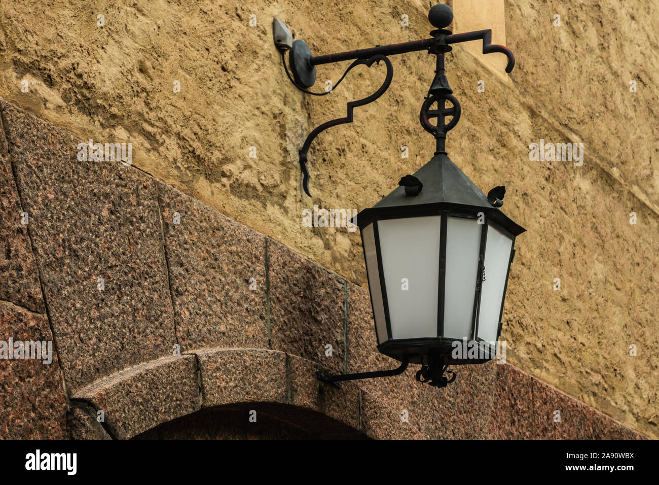 Old lantern hanging on a stone wall of Kuusankoski church, Finland ...