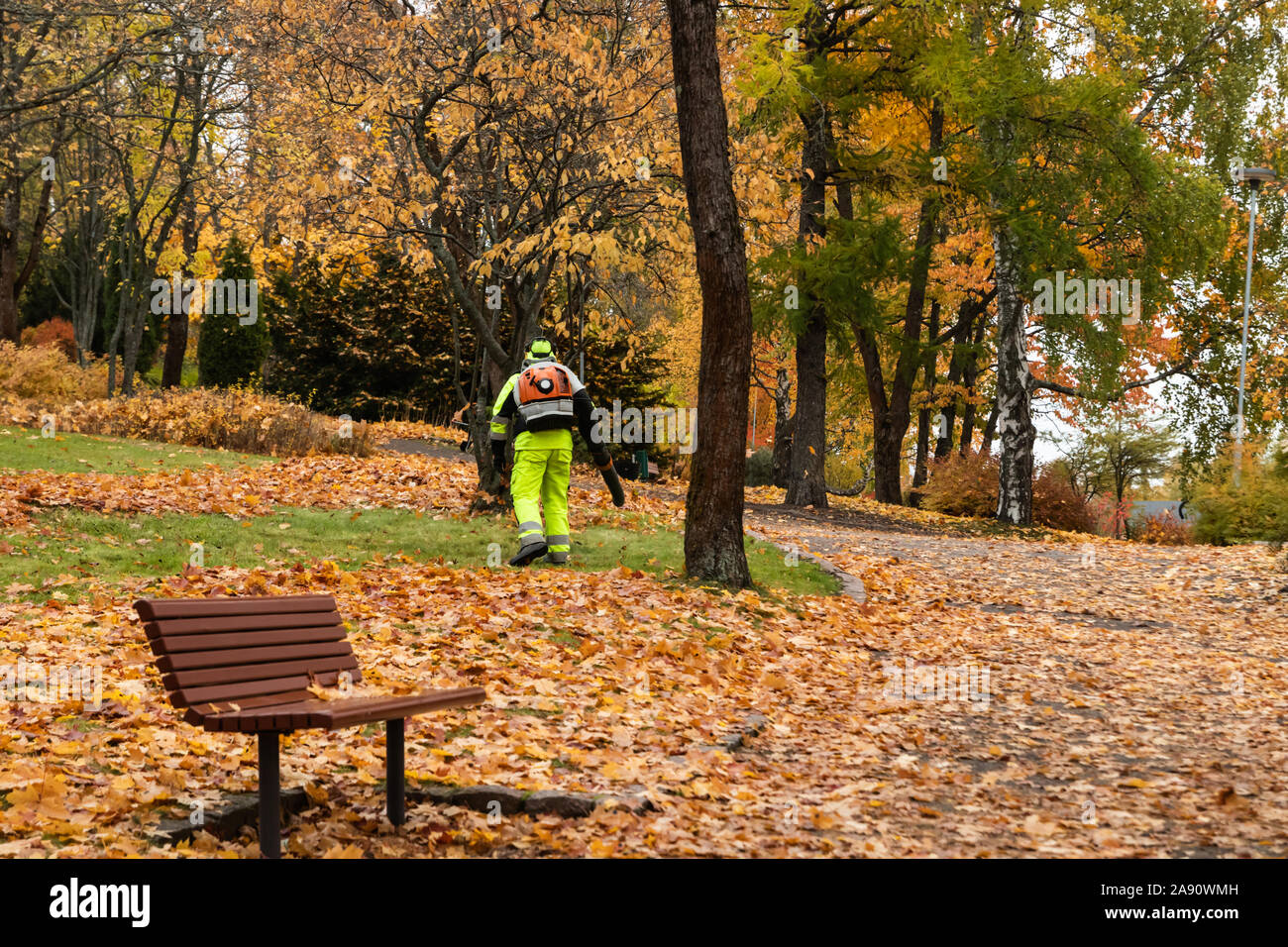 Woman blowing leaves leaf blower hi-res stock photography and images ...