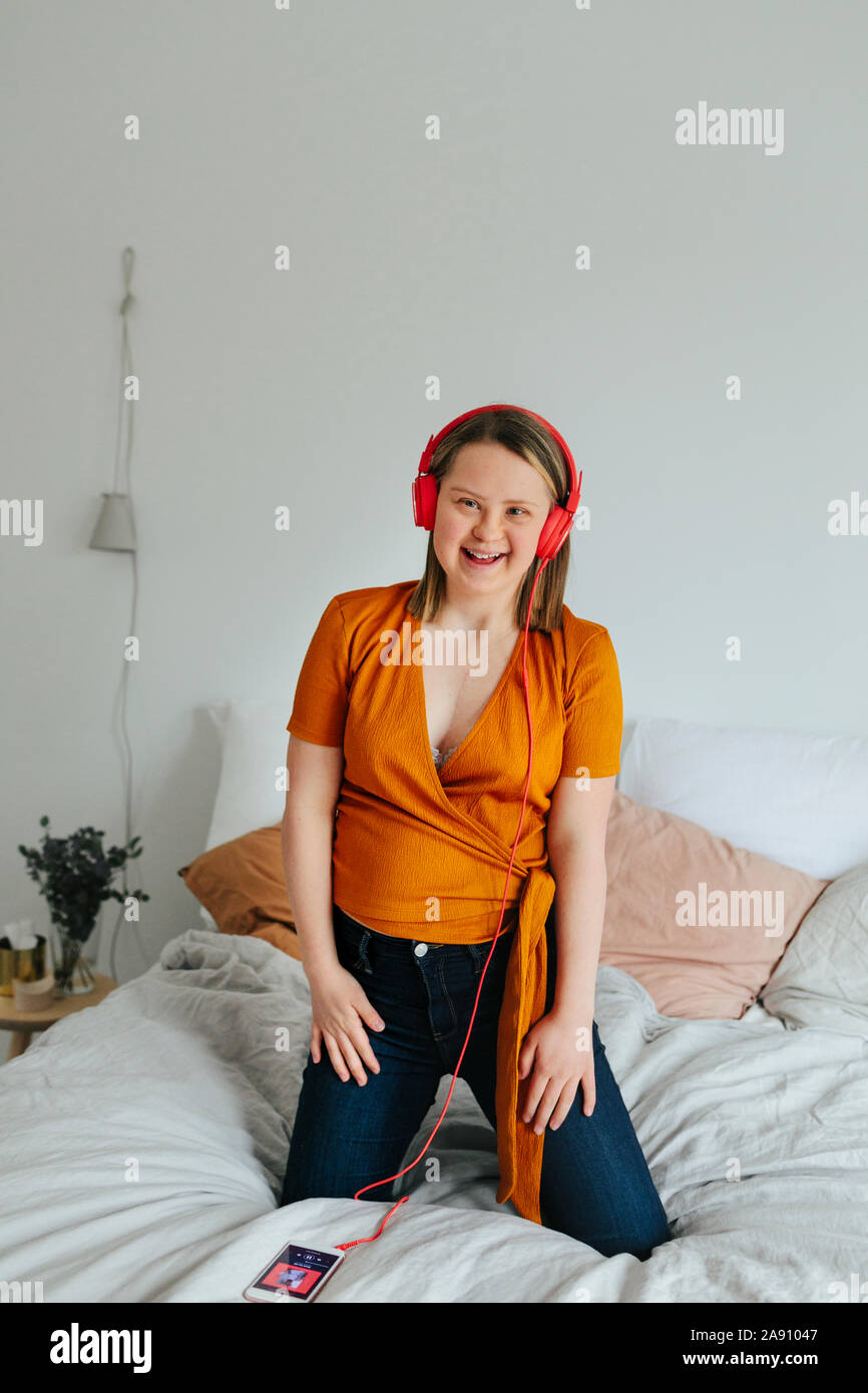Happy teenage girl looking at camera Stock Photo - Alamy