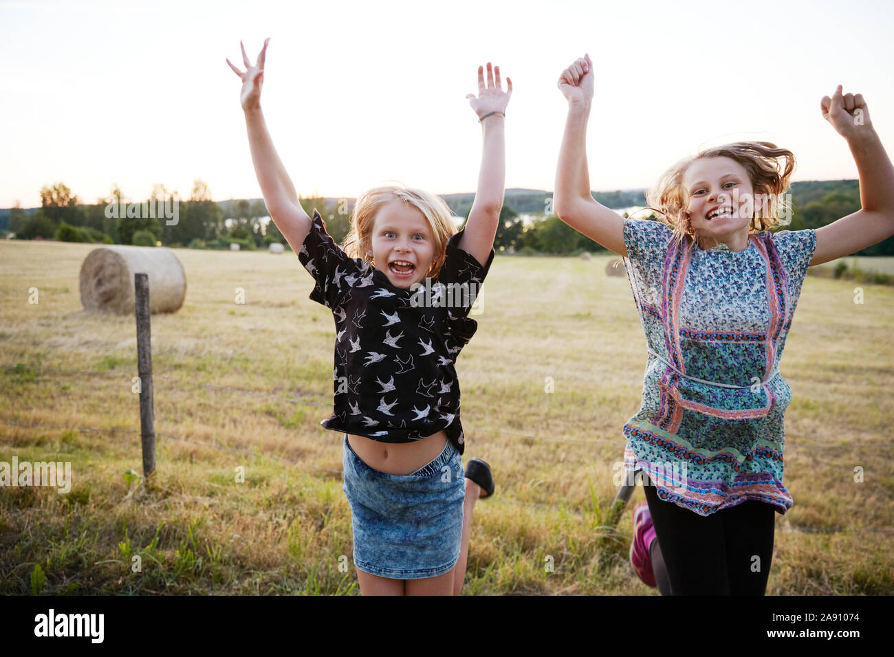 Happy girls jumping Stock Photo - Alamy