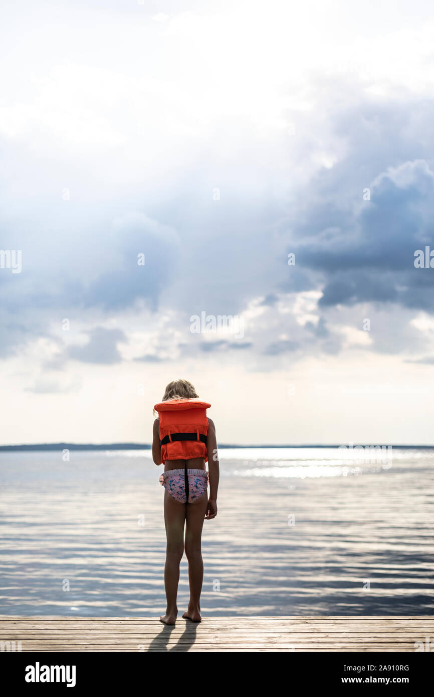 Girl wearing life jacket at sea Stock Photo - Alamy
