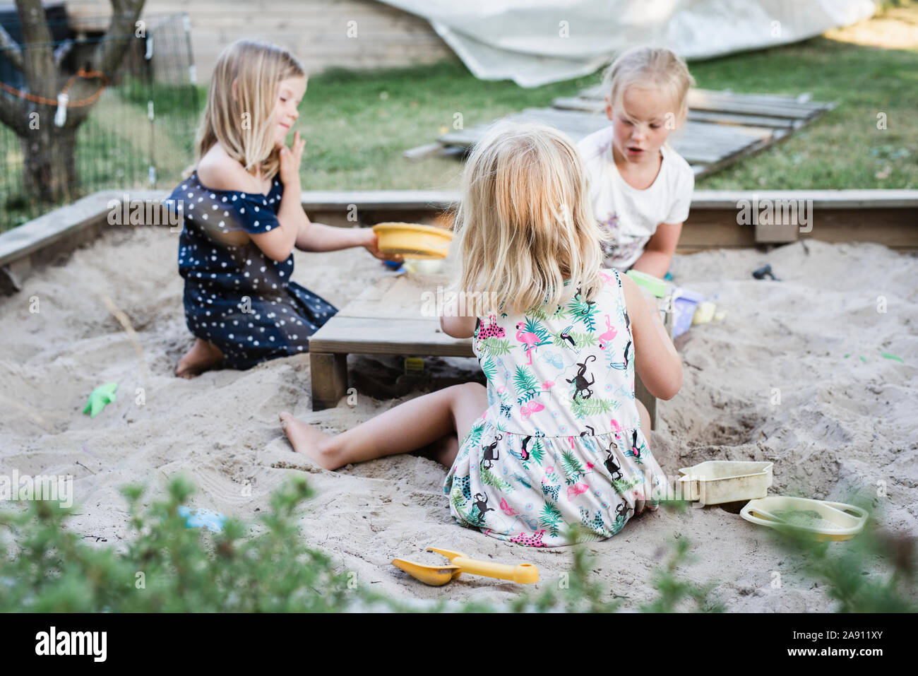 Girls playing in sandpit Stock Photo - Alamy