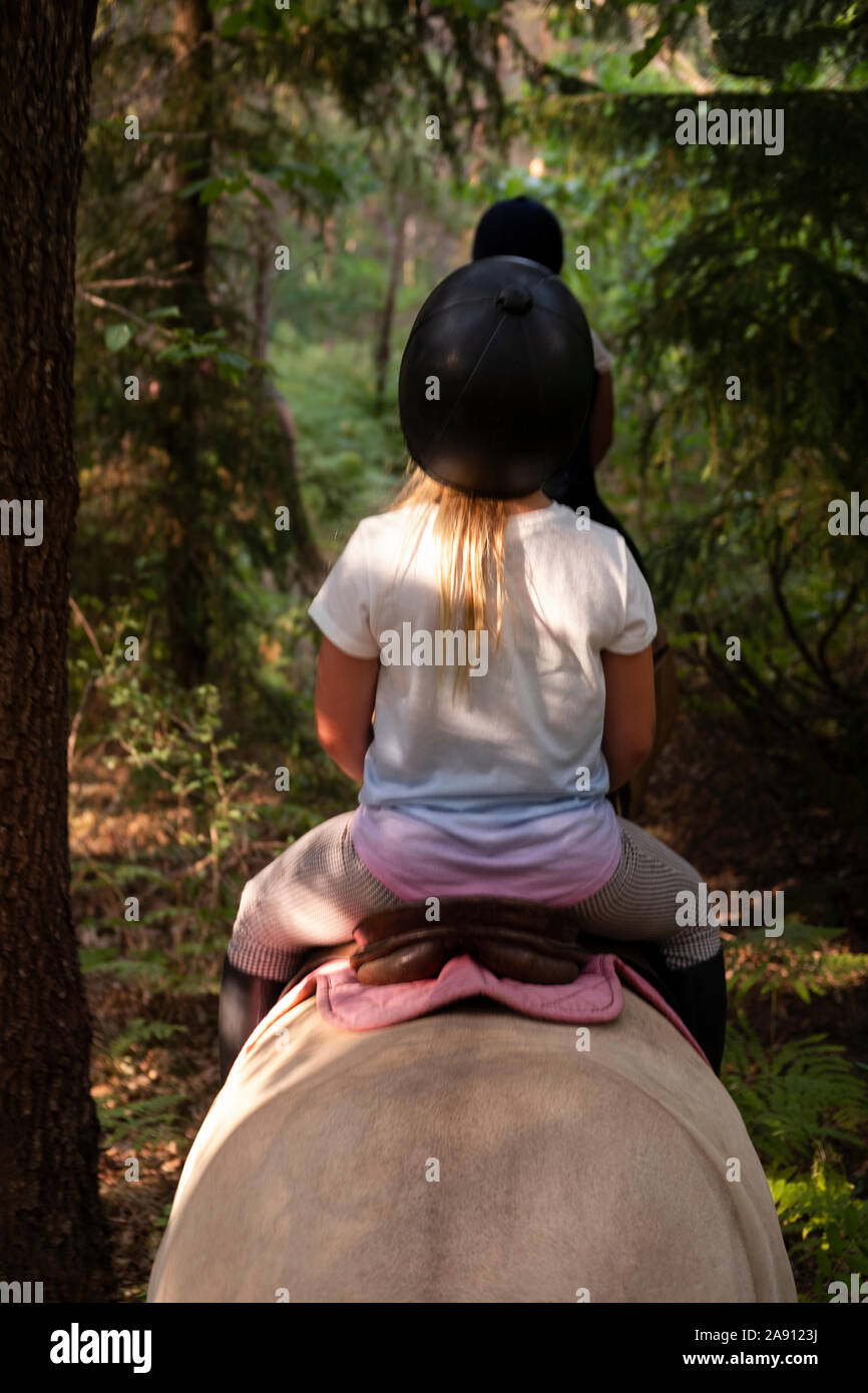 Girl horseback riding Stock Photo - Alamy