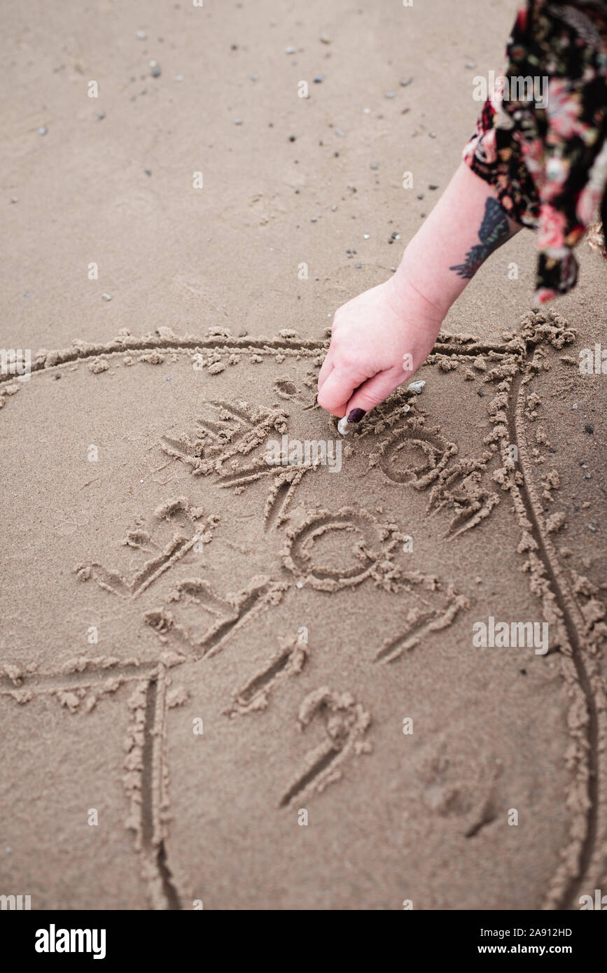 Hand writing on sand Stock Photo - Alamy