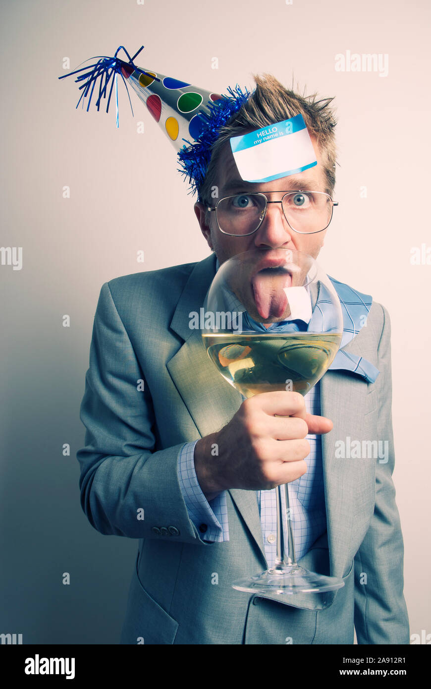 Disheveled office worker wearing a New Year's Eve party hat and a name ...
