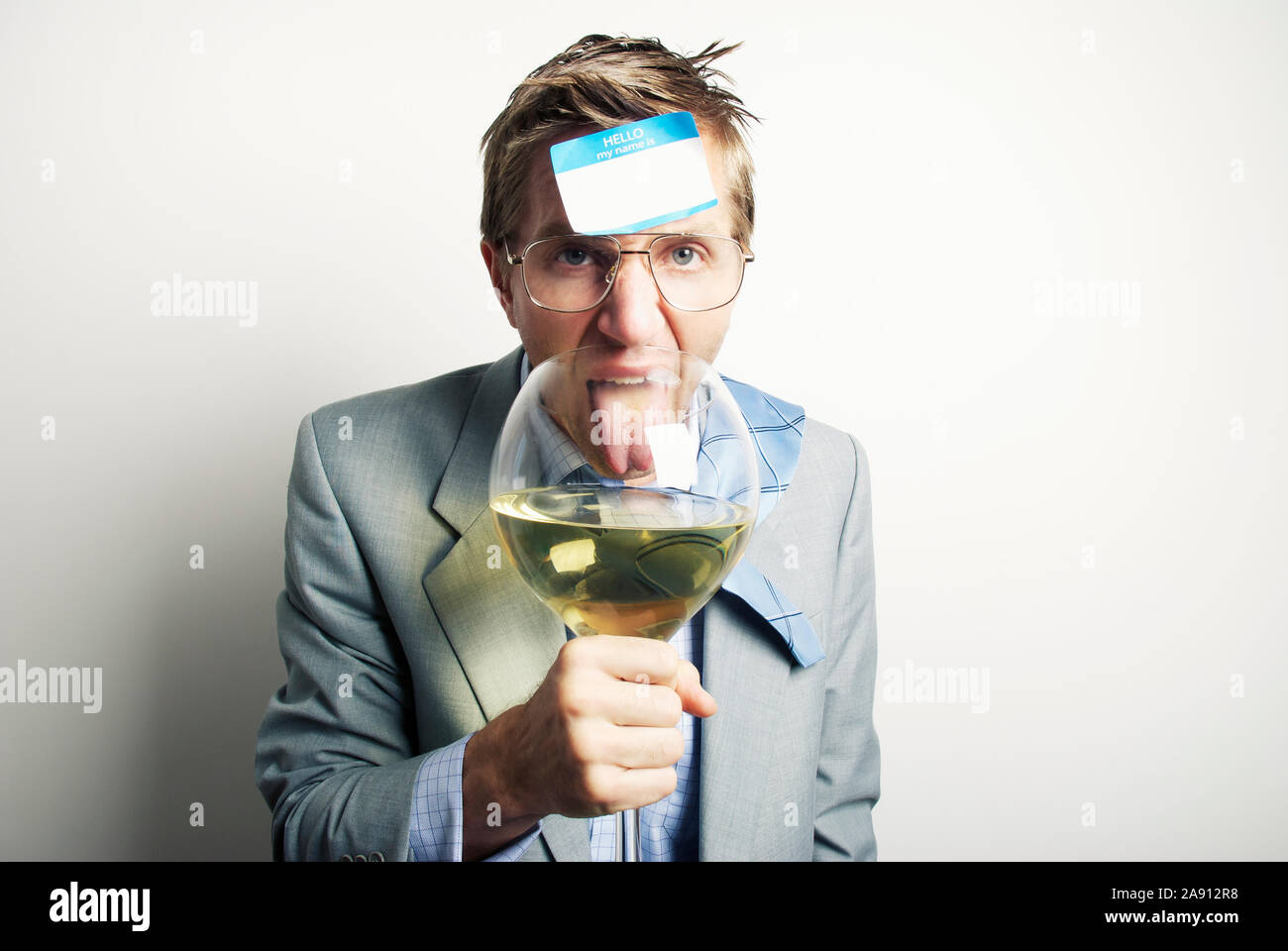 Drunk office worker with a name tag stuck to his forehead licking an ...