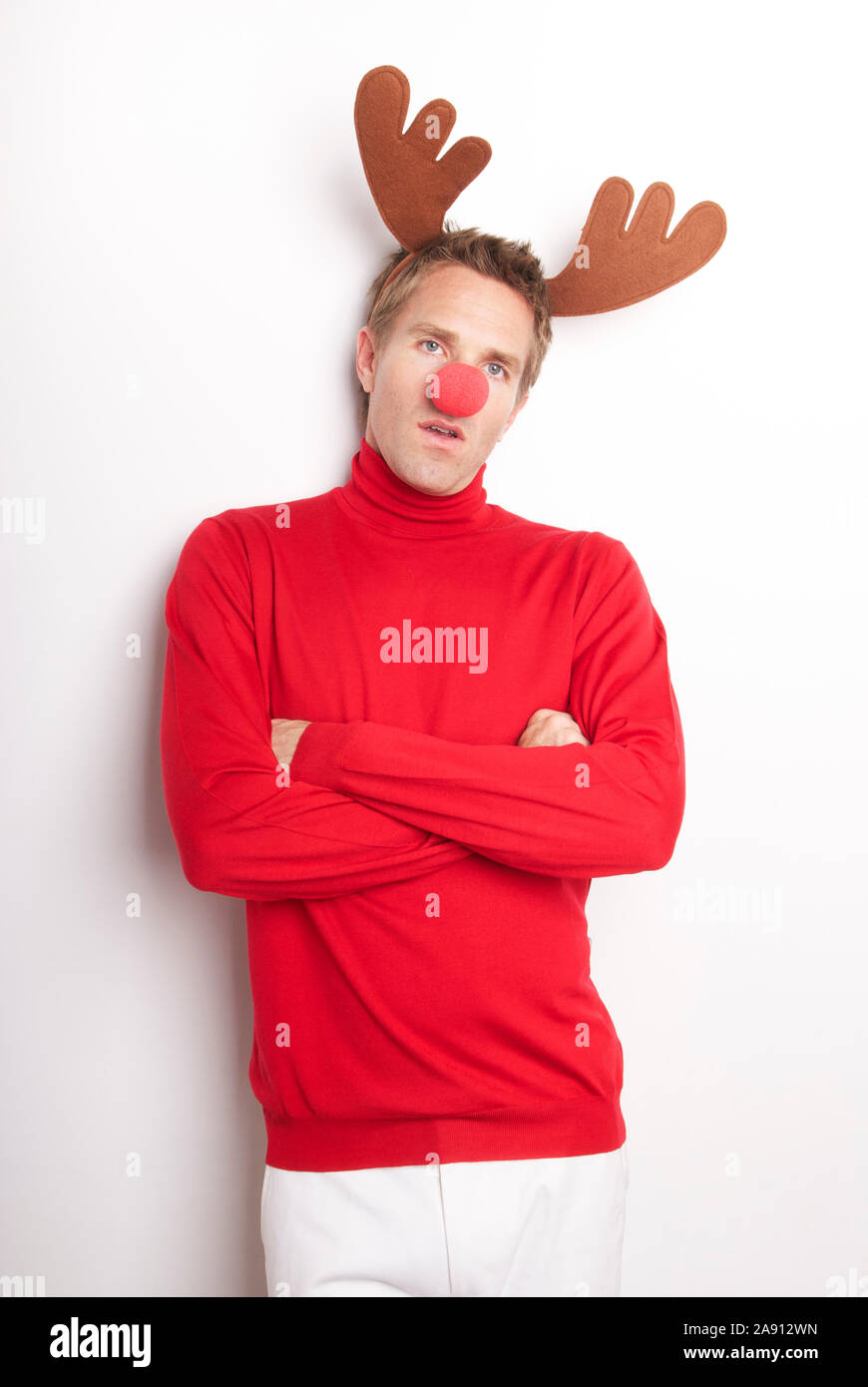 Red-nosed reindeer man standing for a portrait with his hoofs crossed ...