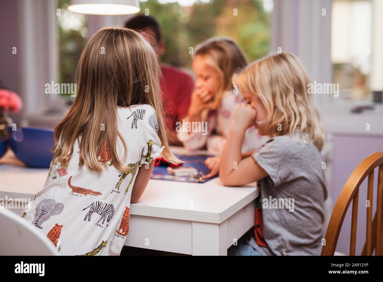 Girls playing board game Stock Photo - Alamy
