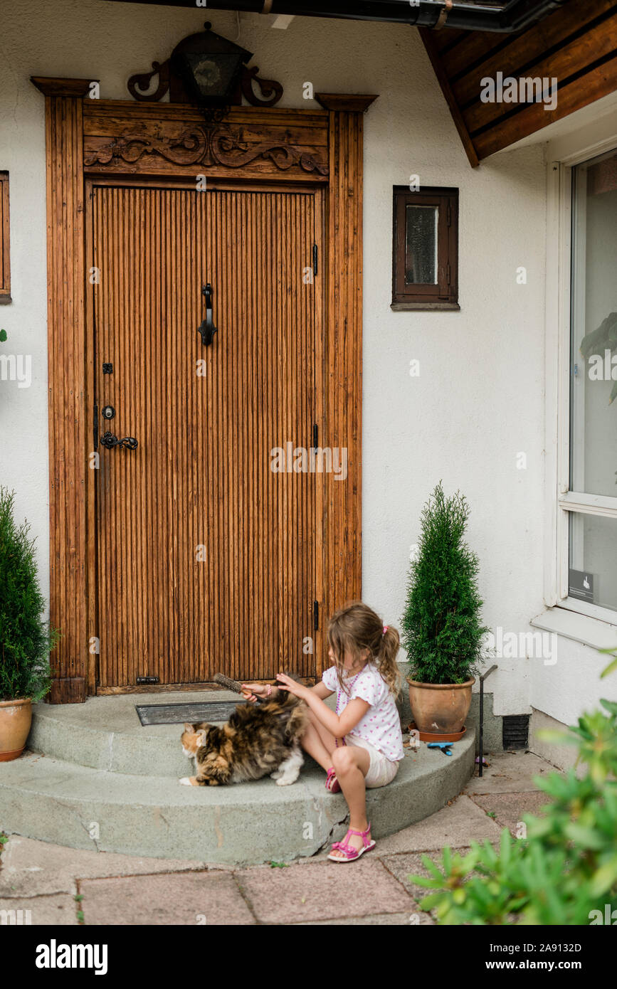 Girl rushing cat Stock Photo - Alamy