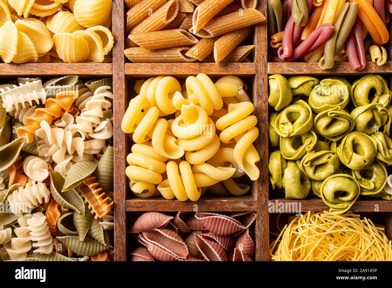 Assorted colorful italian pasta in wooden box Stock Photo - Alamy
