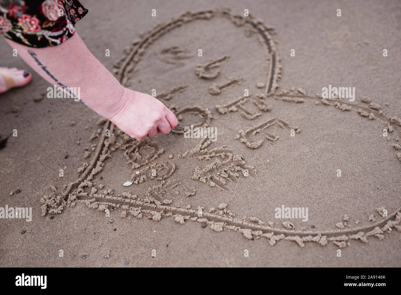 Hand writing on sand Stock Photo - Alamy