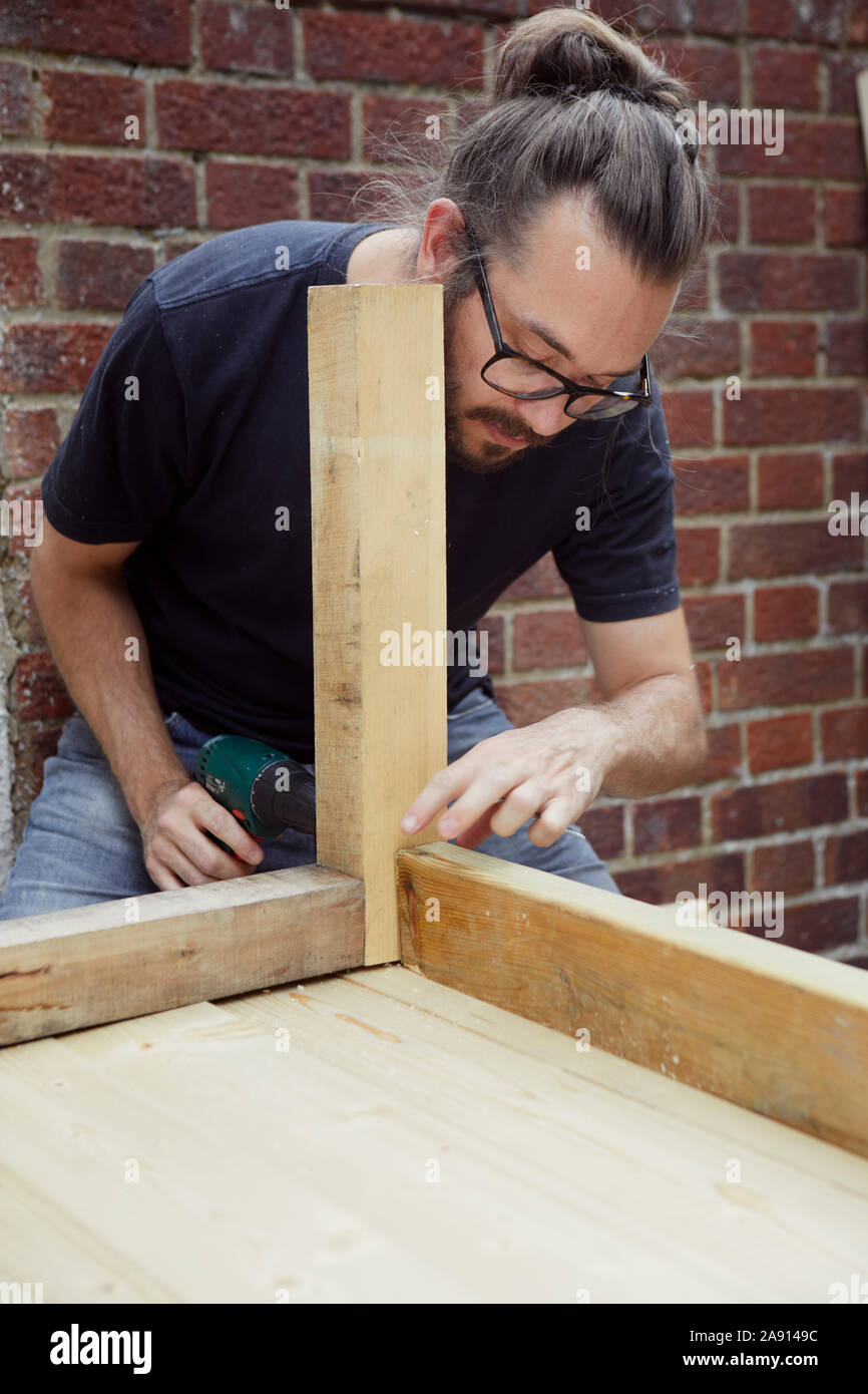 Man making table Stock Photo - Alamy