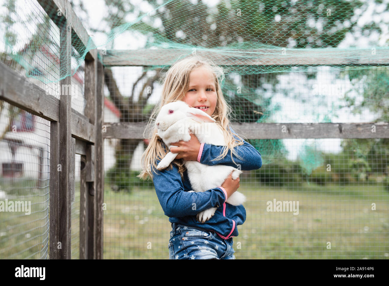 Girl holding rabbit Stock Photo - Alamy