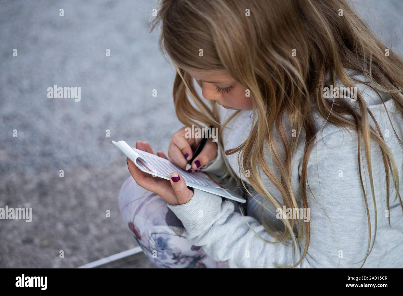 Girl doing notes Stock Photo - Alamy