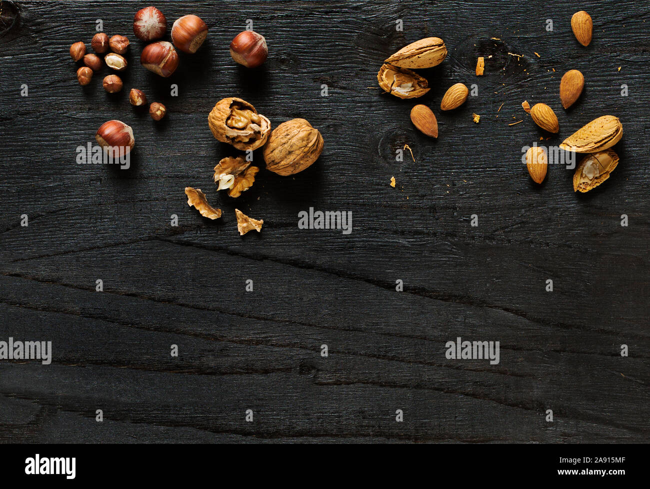 Nuts on black background Stock Photo - Alamy
