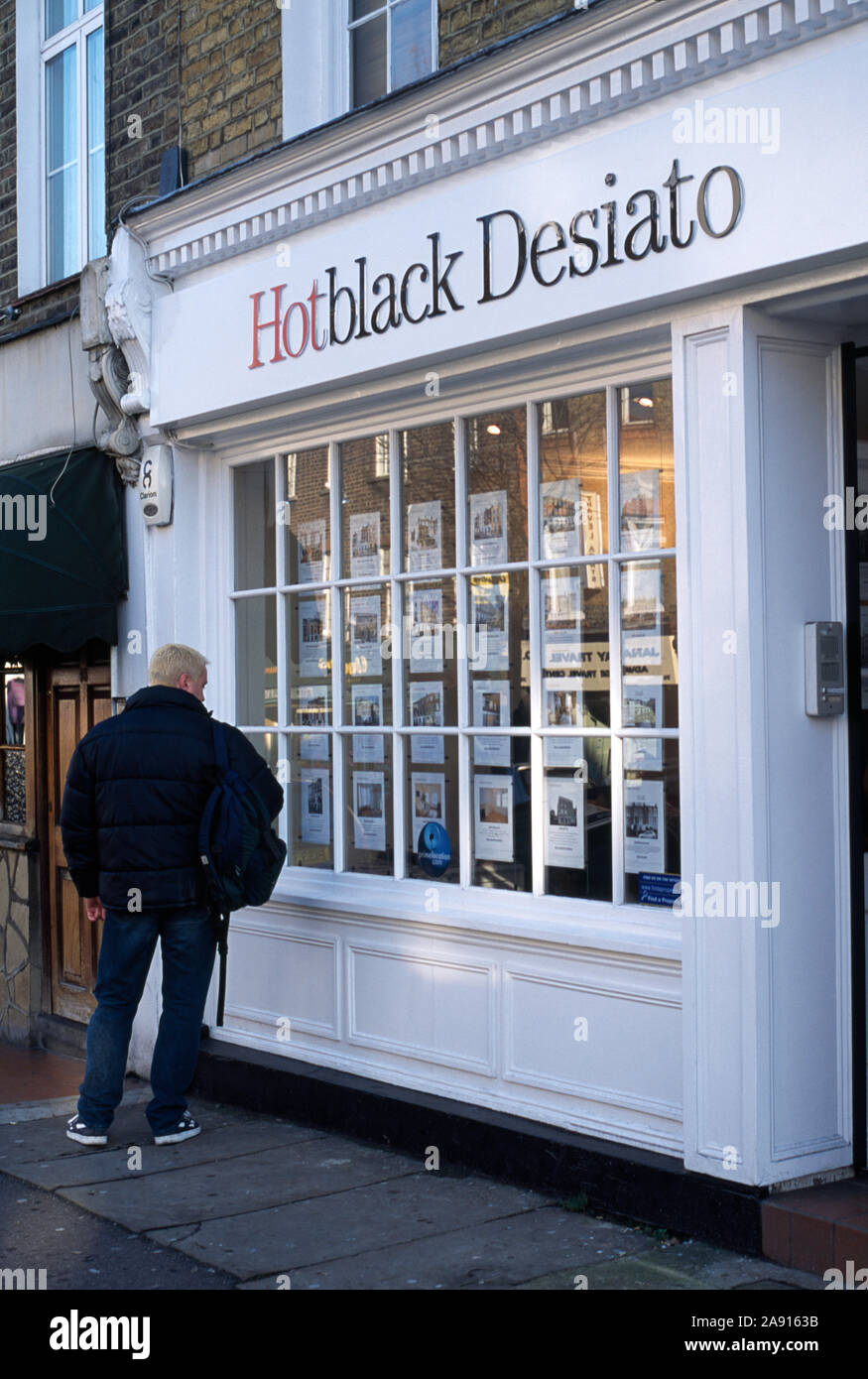 Browsing an estate agent's window in Camden London Stock Photo - Alamy