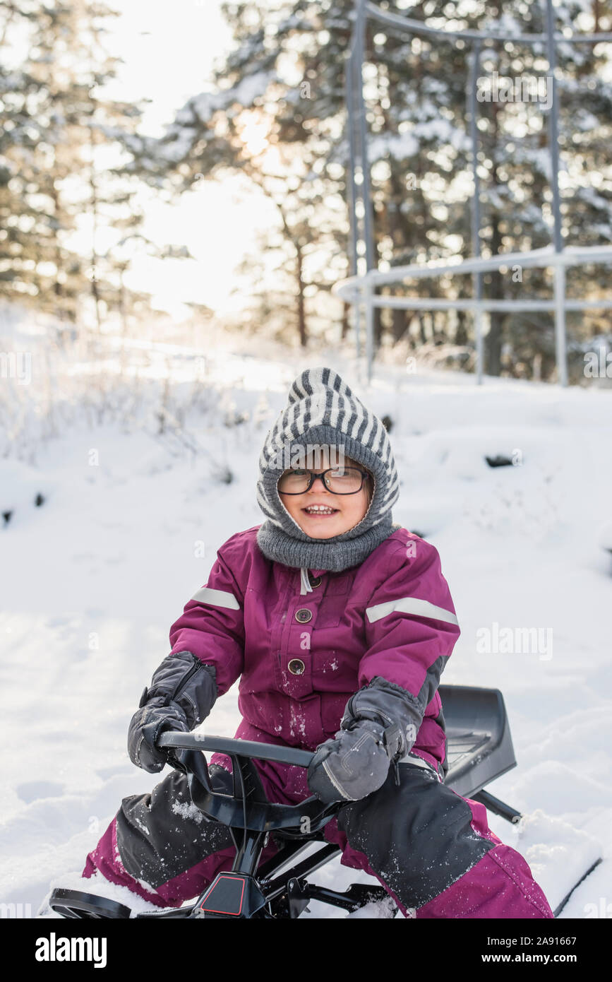 Girl on sledge Stock Photo - Alamy