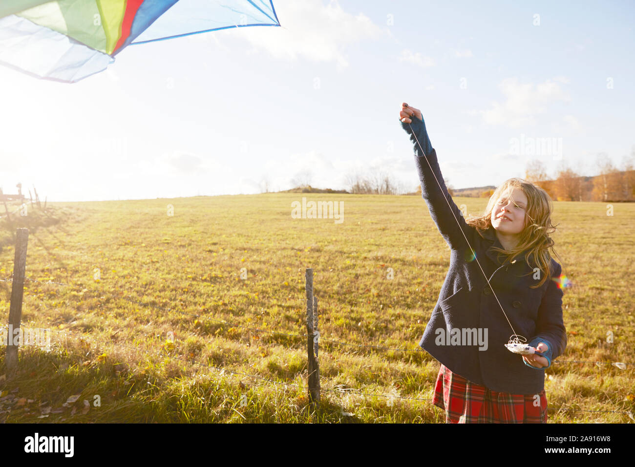 Girl flying kite Stock Photo - Alamy