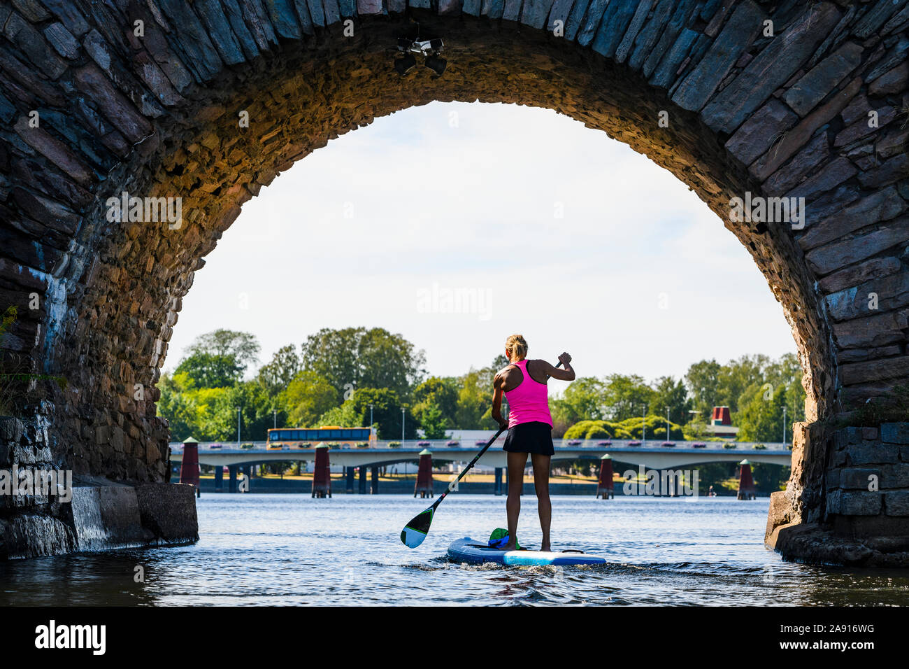 Woman paddle boarding Stock Photo - Alamy