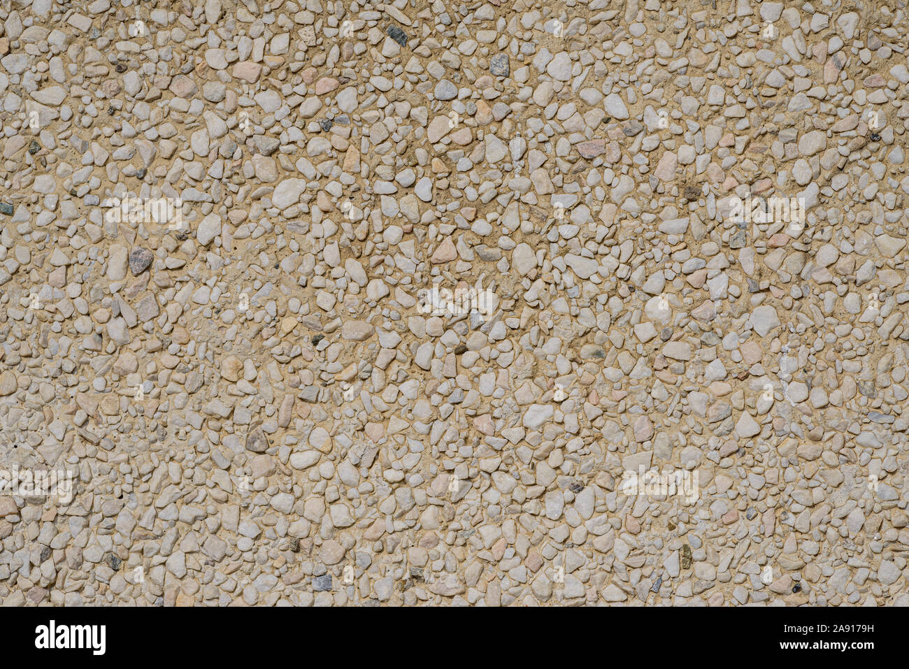 Wall with small stones. Texture background Stock Photo - Alamy