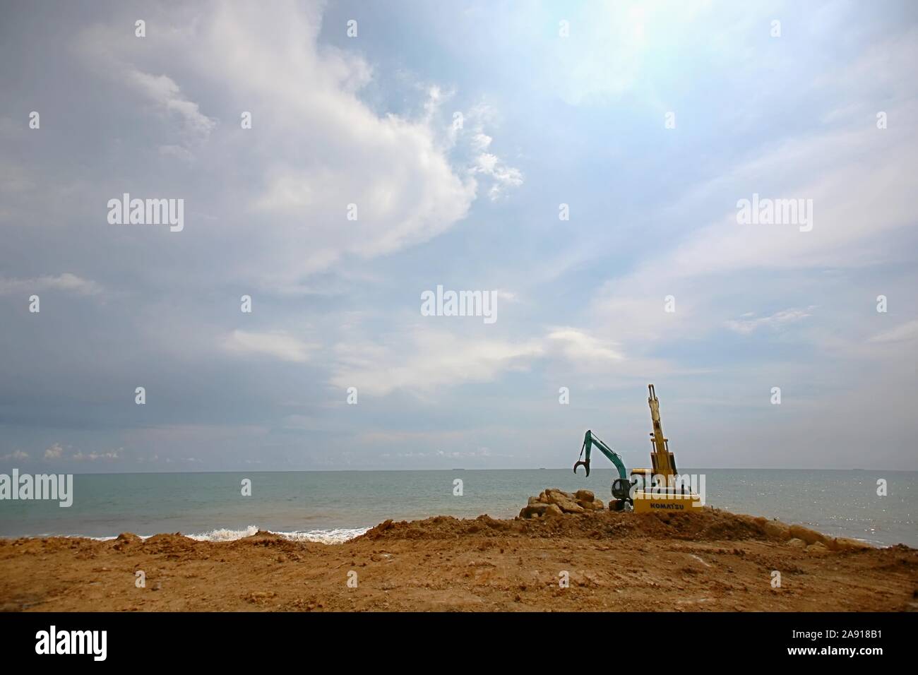 Excavator parked at seaside construction project area Stock Photo - Alamy