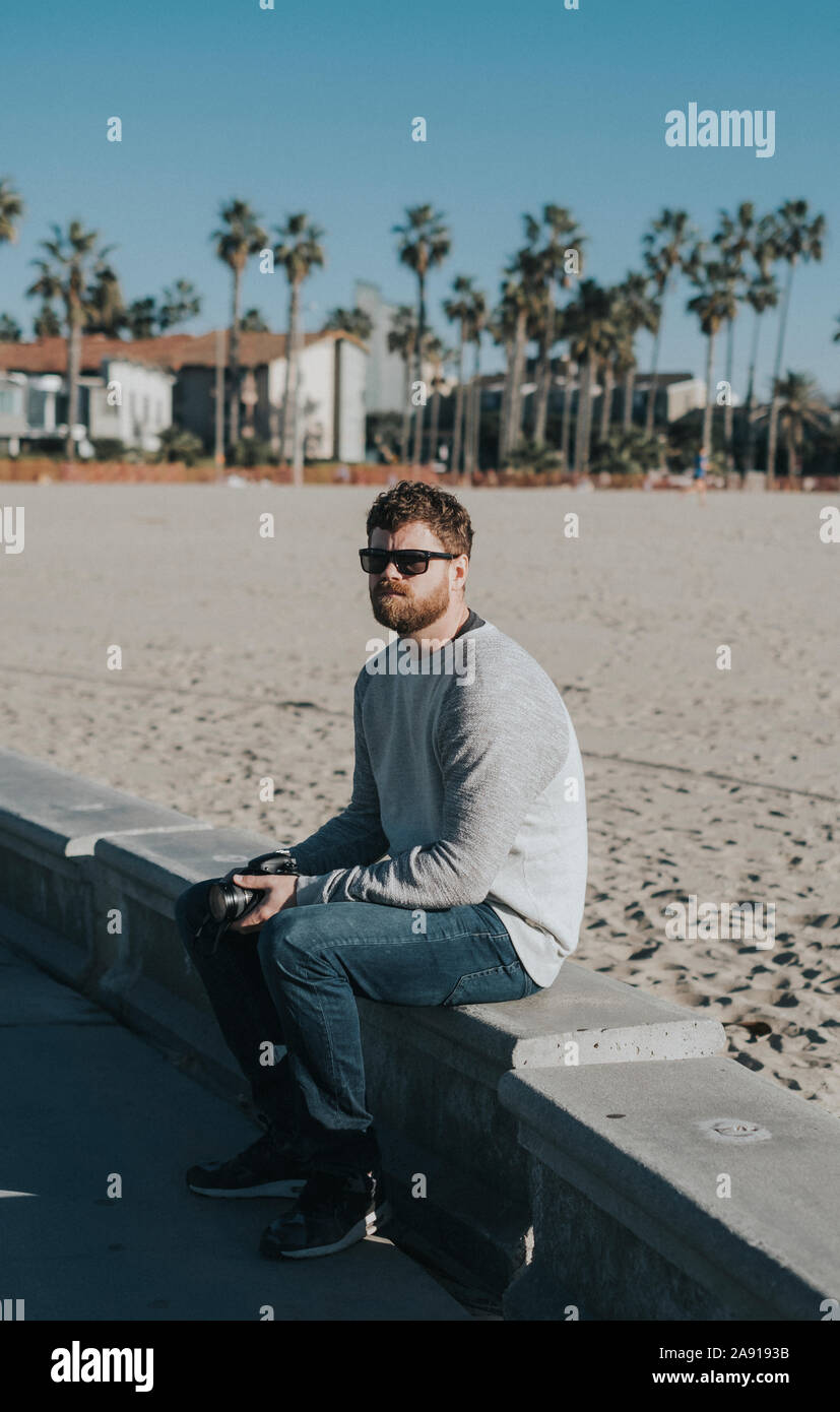Man sitting on beach Stock Photo - Alamy
