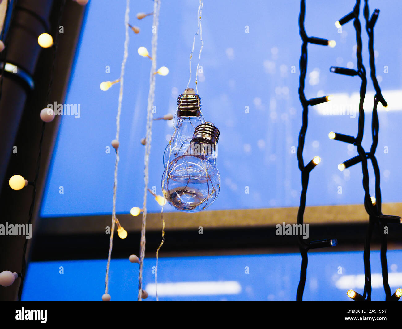 Garlands are hanging on the window. multi-colored light bulbs garlands ...