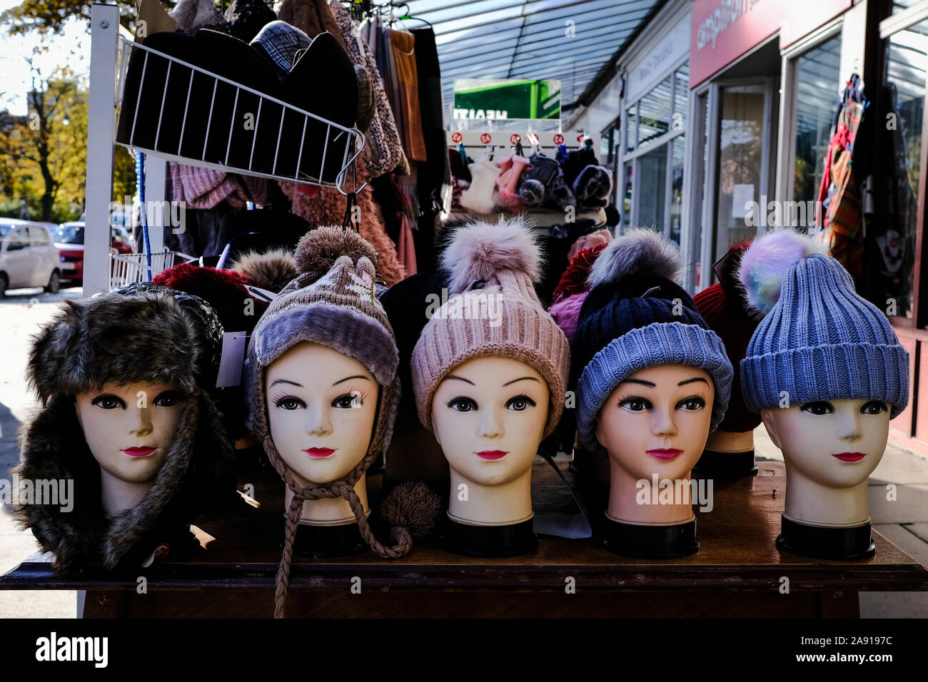 Warm hats adorning dummy heads on the shopping street in Southport, UK ...