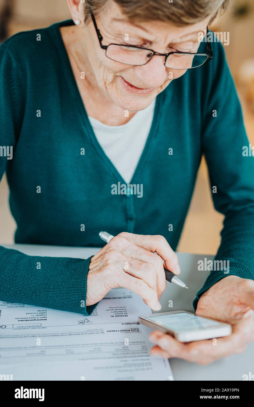 Elderly person doing paperwork hi-res stock photography and images - Alamy