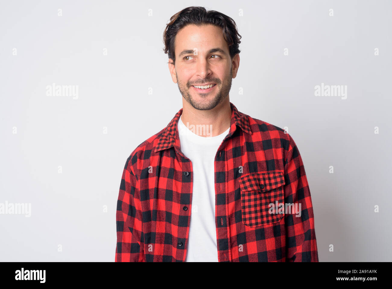 Face of happy Hispanic hipster man thinking Stock Photo - Alamy