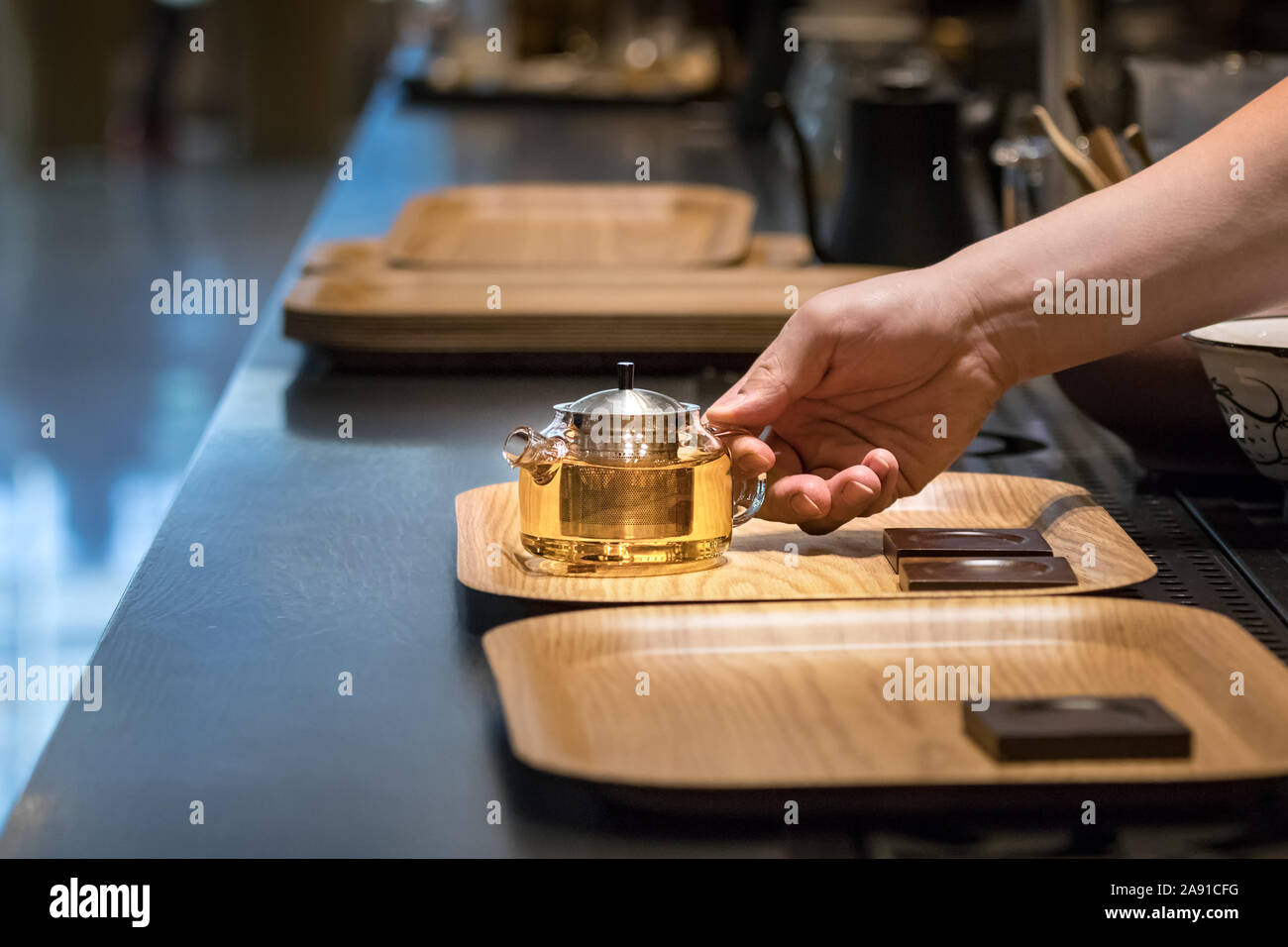 Hands with teapot hi-res stock photography and images - Alamy