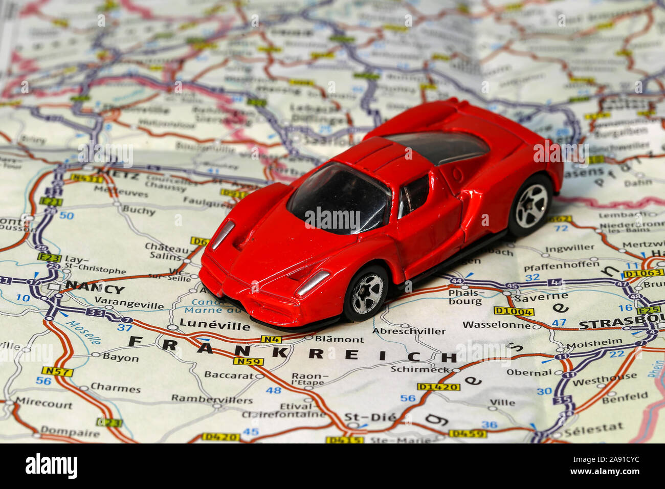 Planning a car trip to France. Toy car is on a country map Stock Photo ...