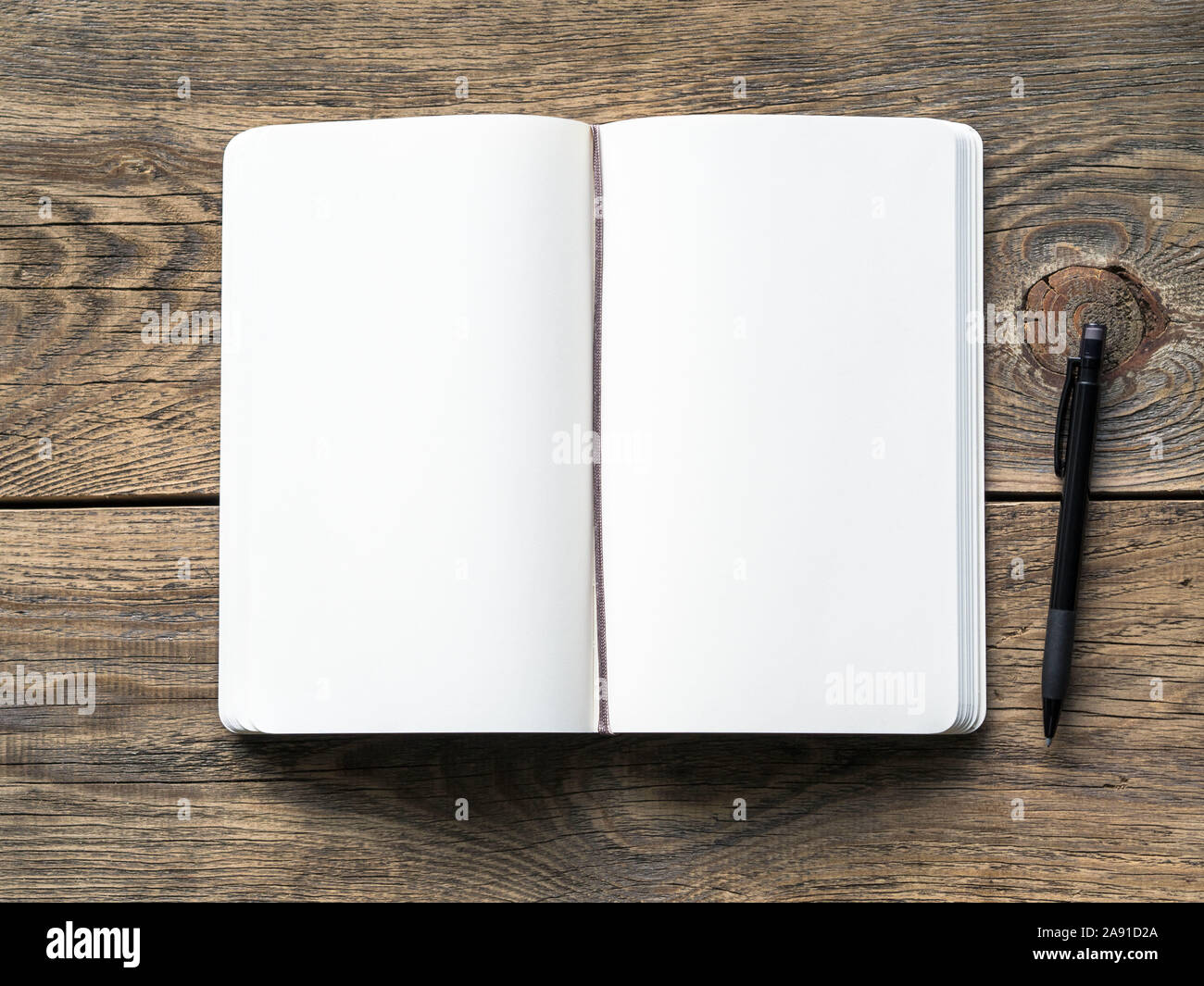 Open notebook on a spring with a white paper for notes and drawing with ...