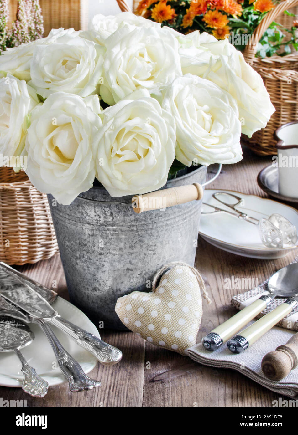 White roses in a bucket Stock Photo - Alamy