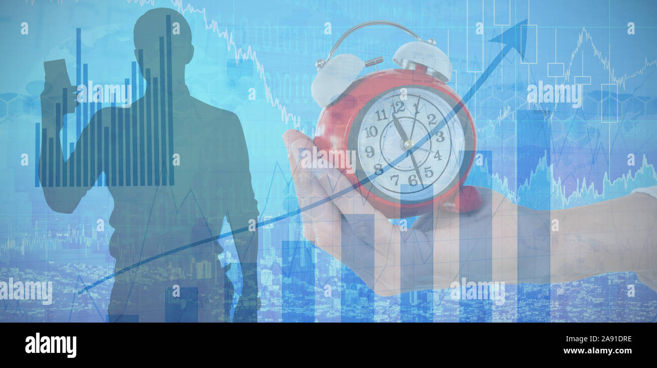 Composite image of cropped hand holding alarm clock Stock Photo - Alamy