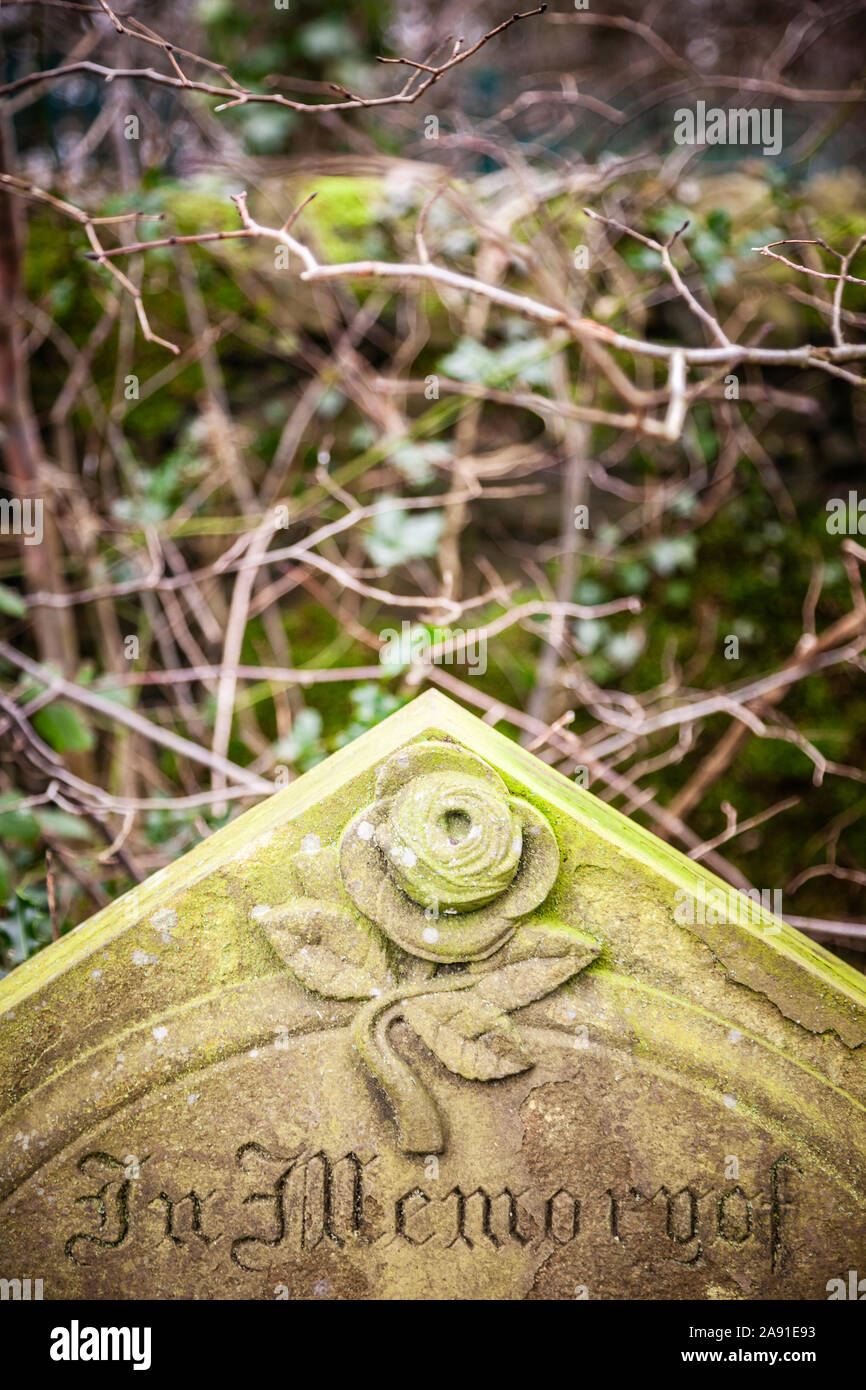 Top of a gravestone in an overgrown cemetery Stock Photo - Alamy