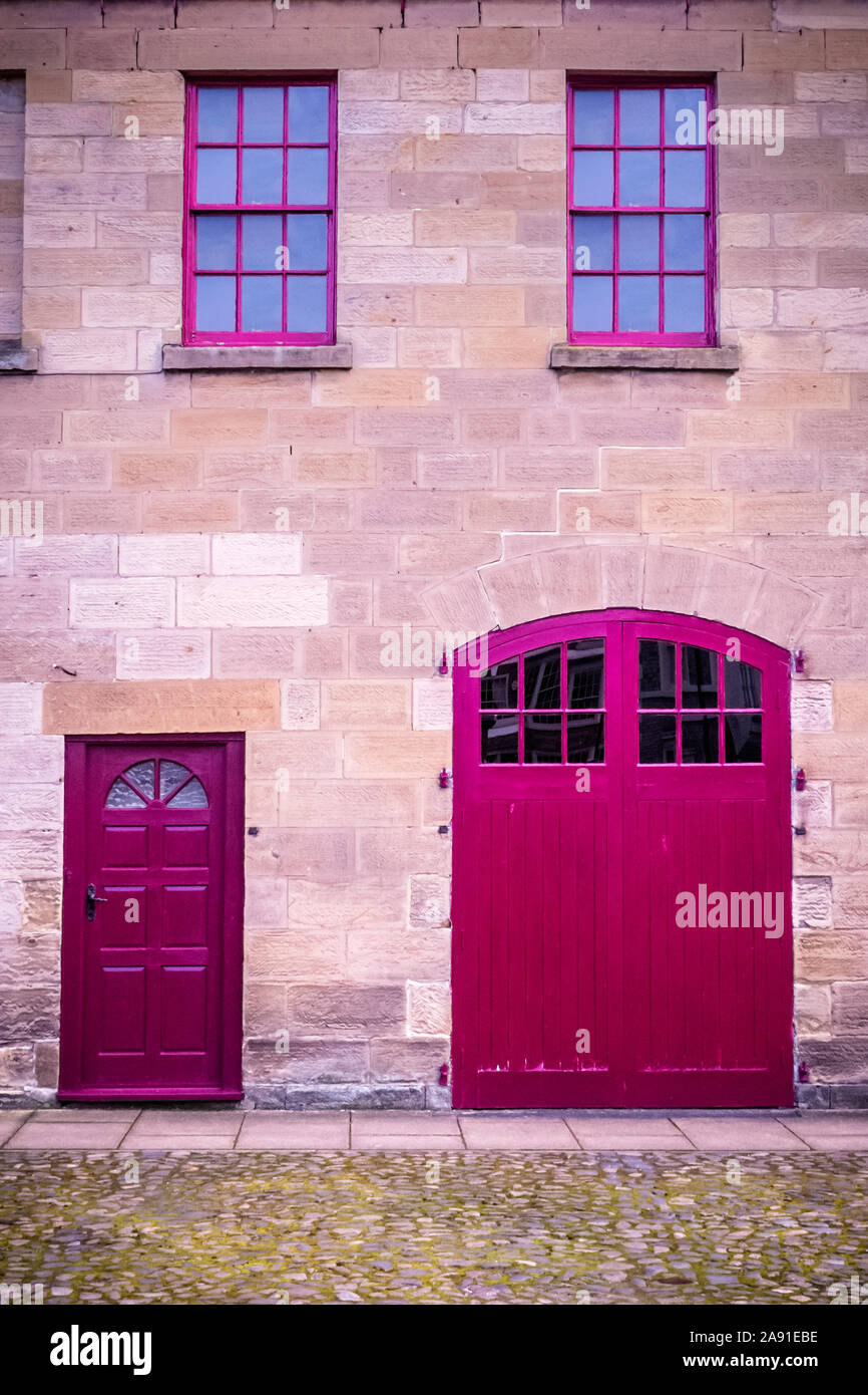 Red windows and doors in an old stone building Stock Photo - Alamy
