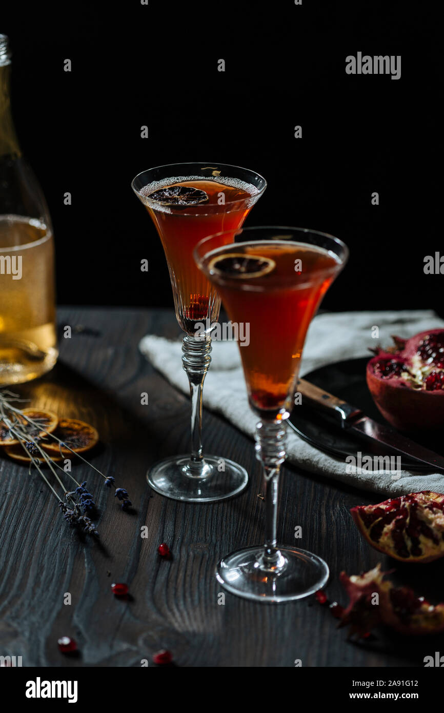 Prosecco pomegranate cocktail, garnished with dryed lemon slice Stock ...