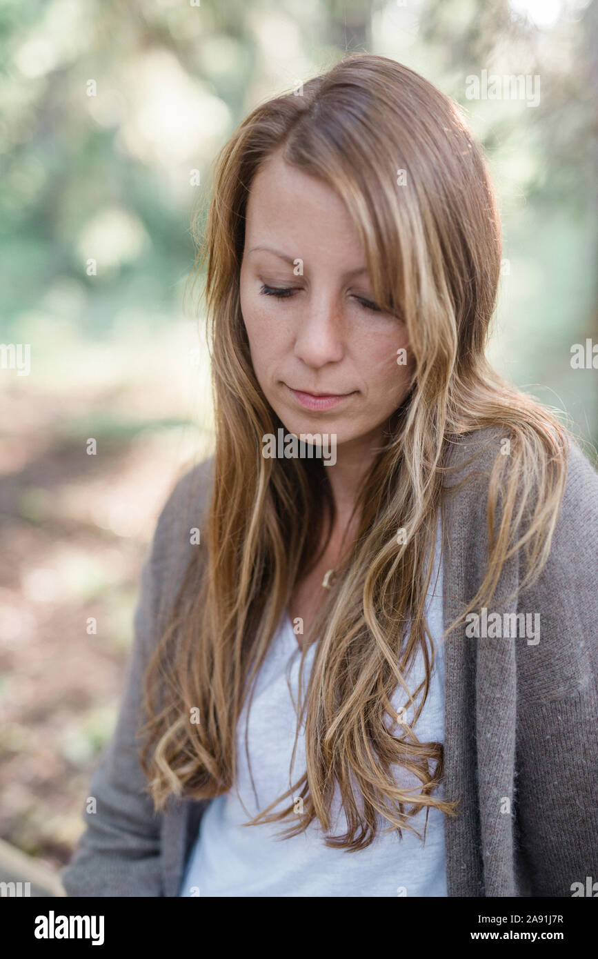 Woman looking down Stock Photo - Alamy