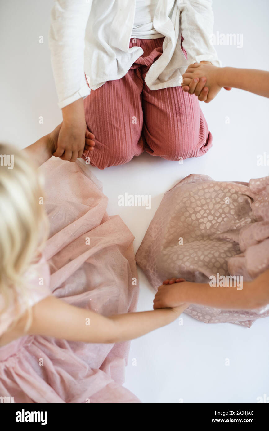 Girls holding hands Stock Photo - Alamy