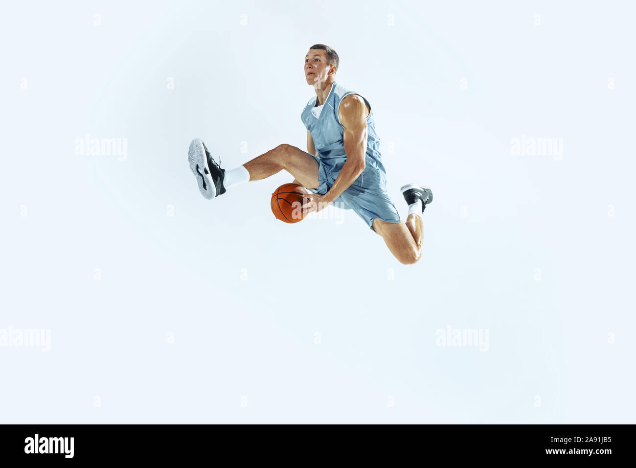 High flight. Young caucasian basketball player of team in action ...