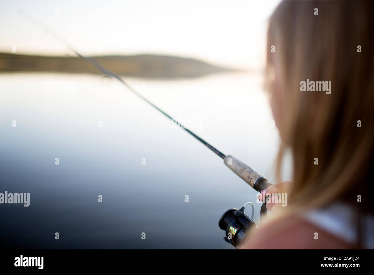 Girl fishing in lake Stock Photo - Alamy
